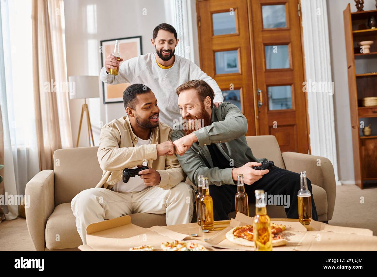 Three handsome, interracial men in casual attire cheerfully sit around ...
