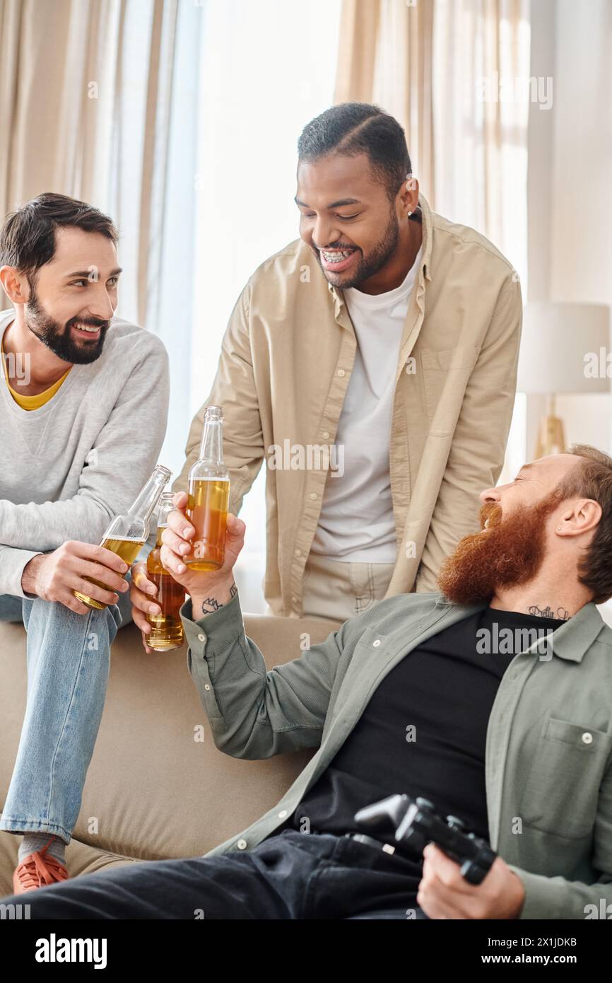 Three cheerful, handsome men of different races in casual attire ...