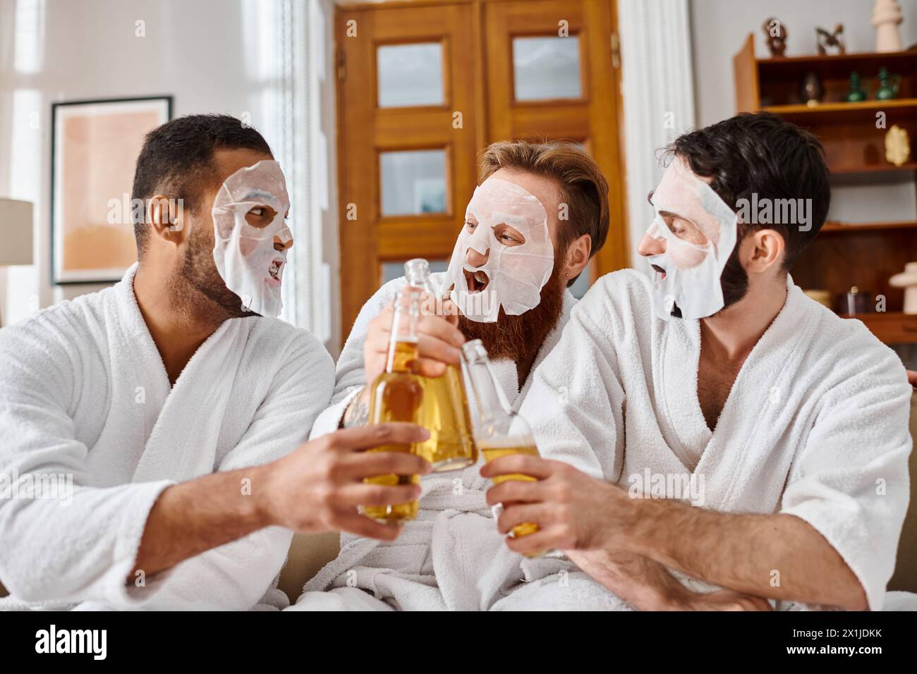 Three diverse men in bathrobes, masks on, enjoying beers together Stock ...