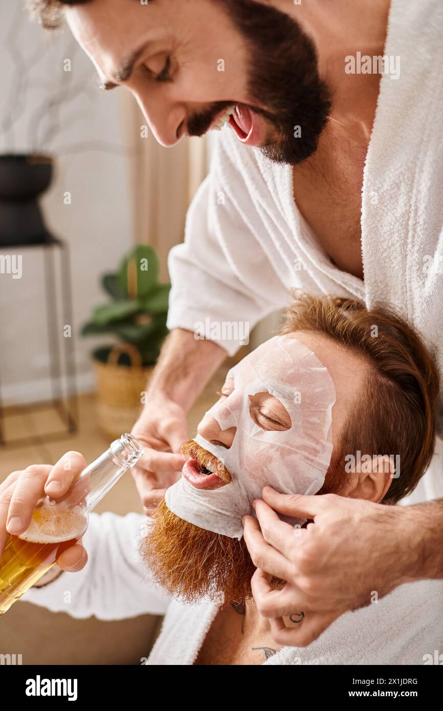 Two cheerful men in bathrobes enjoy a bonding moment as one gently ...