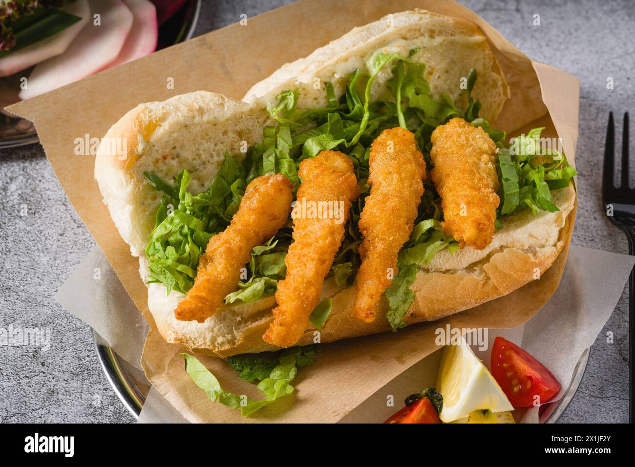 Deep fried shrimp in bread with greens on the side. Shrimp sandwich ...
