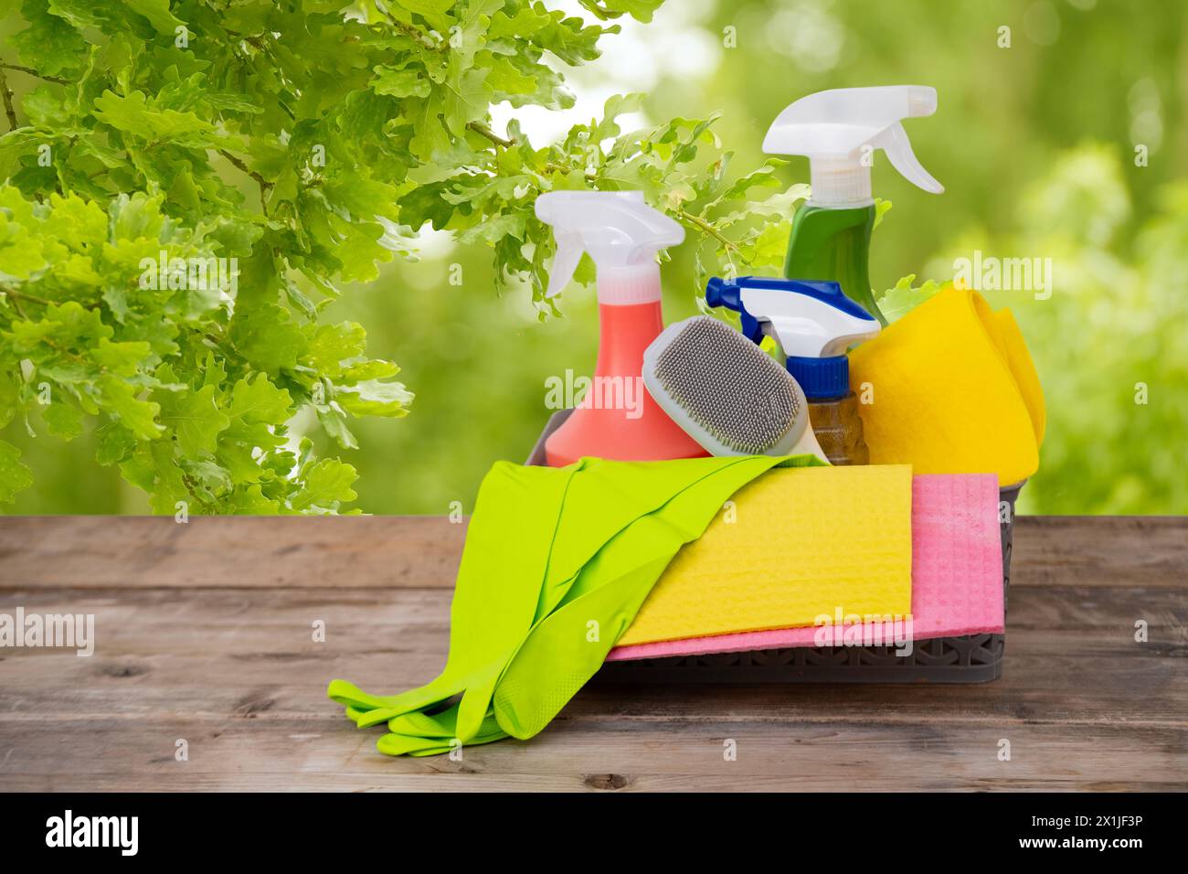 Basket with cleaning items on blurry spring background, spring home ...