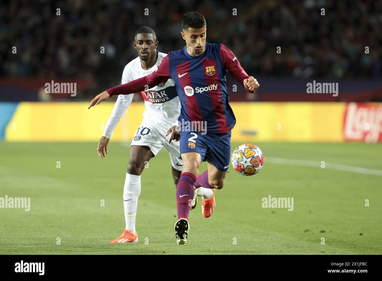Joao Cancelo of Barcelona, left Ousmane Dembele of PSG during the UEFA ...