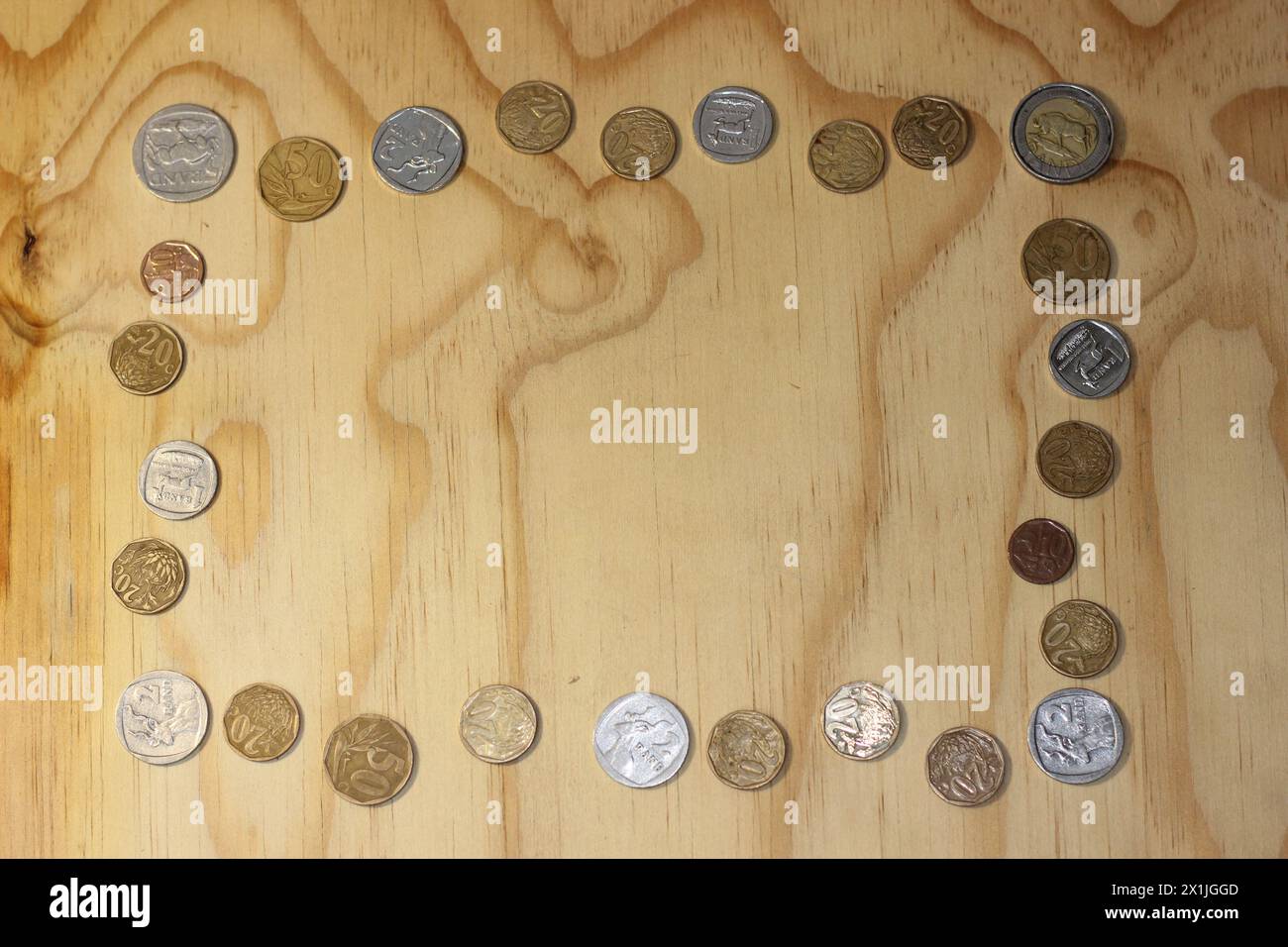 Wood desk table background with money coin border frame Stock Photo - Alamy