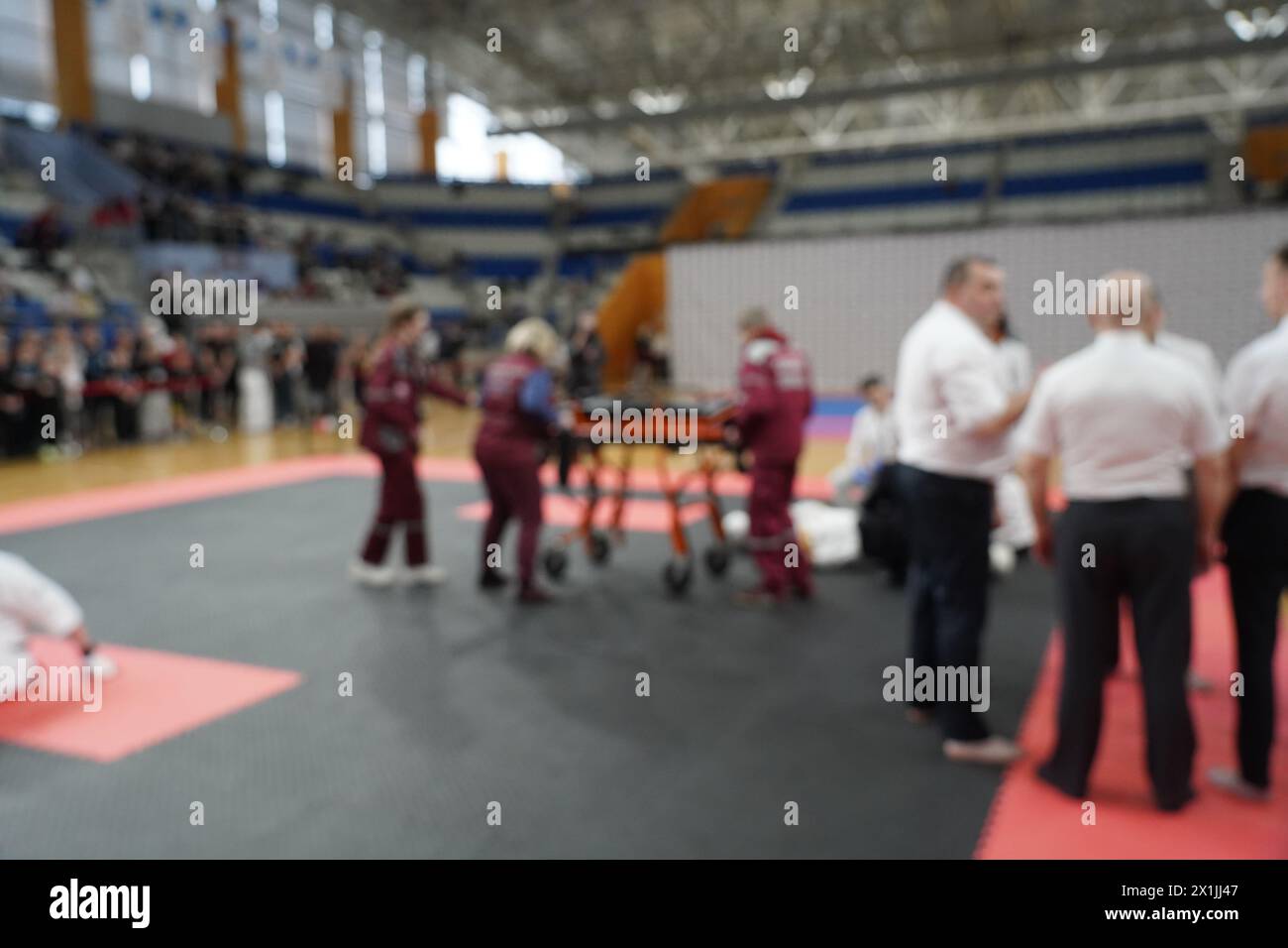 A team of doctors provides assistance to an athlete who was injured in ...