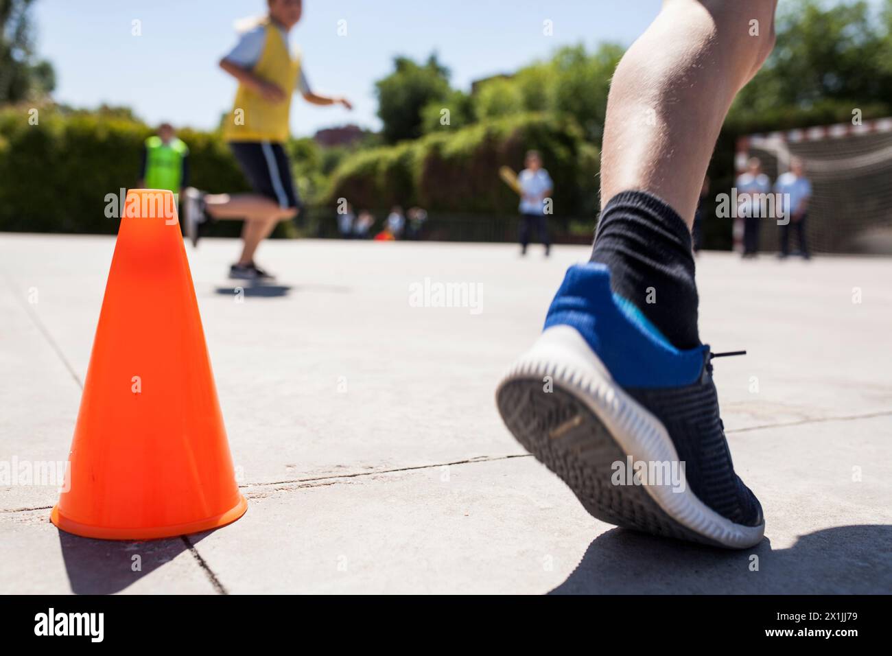 children running in physical education class, close-up of a foot with ...