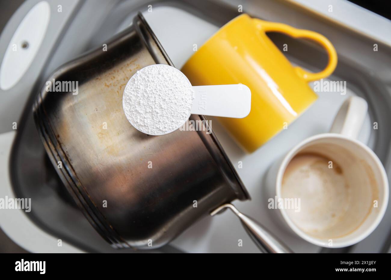 measuring spoon with granules of environmentally friendly oxygen bleach ...