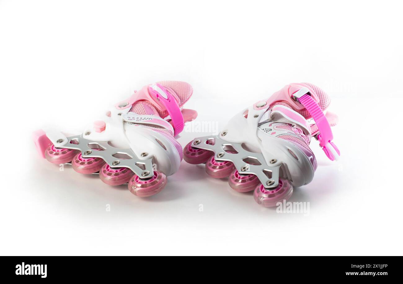 Pink girlish roller skates on a white background, isolate. Close-up ...
