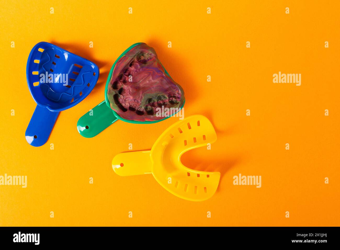 Multi-colored dental spoons for taking an impression of the dental jaw ...