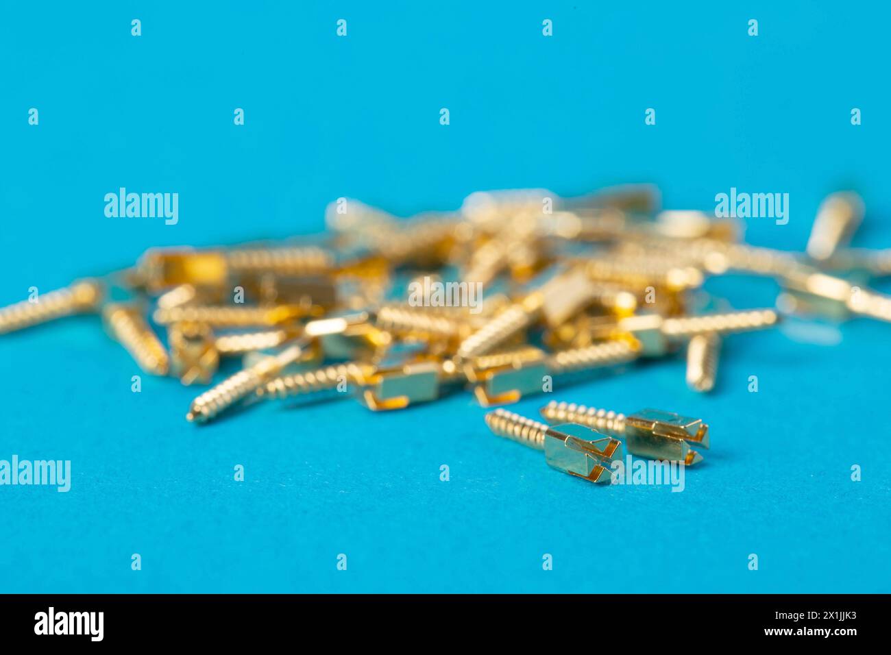 Lots of metal dental pins on a blue background. The concept of ...