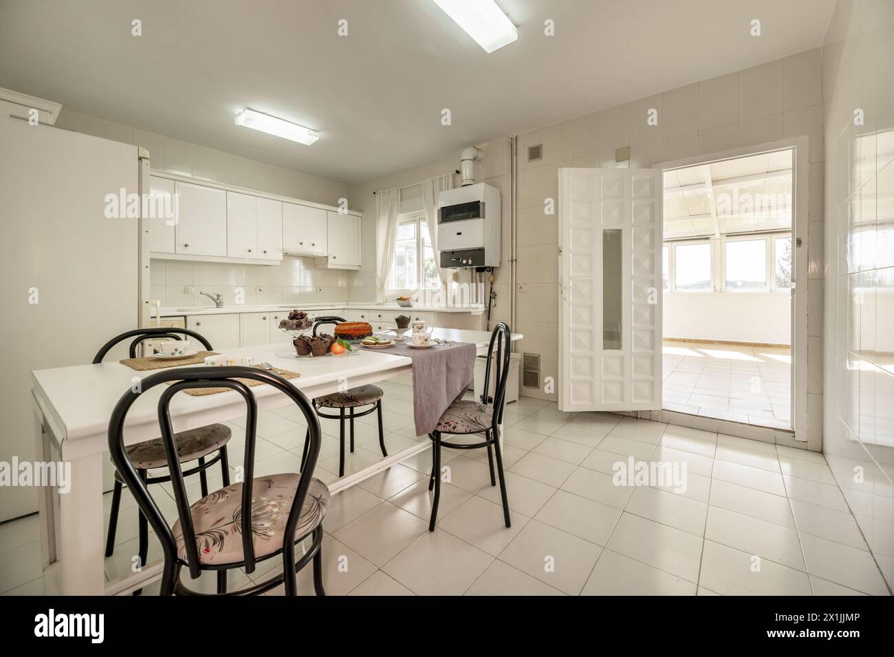 Large breakfast table with food, sweets, tablecloths and bowls in a ...