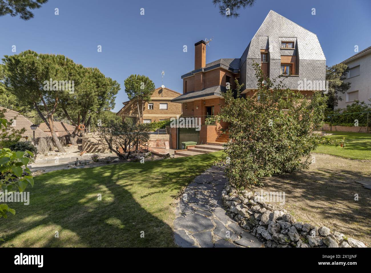 Estate with slate tile paths and chalet with characteristic roof of the ...