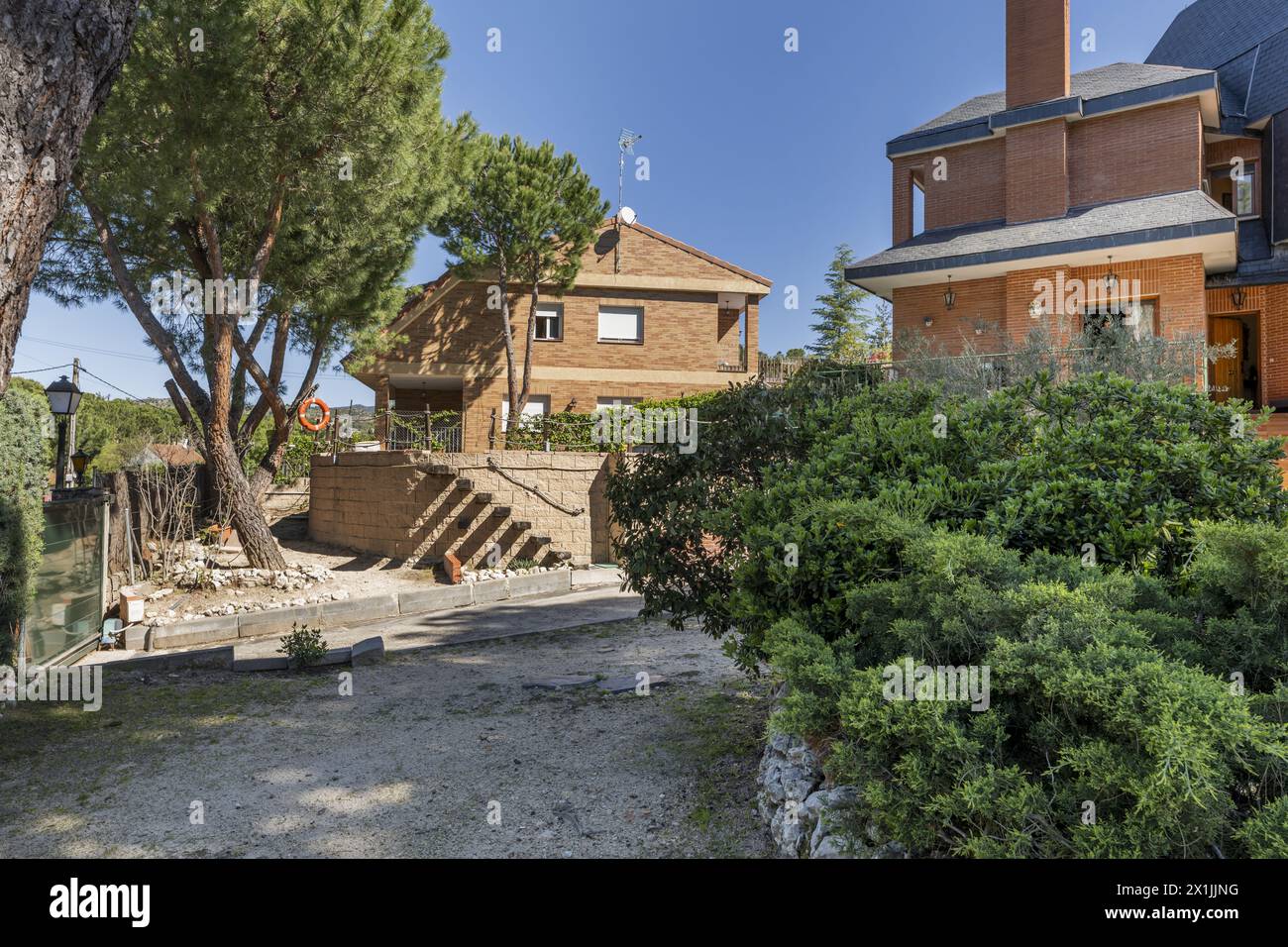 Estate with sandy paths, chalet with characteristic black slate tile ...