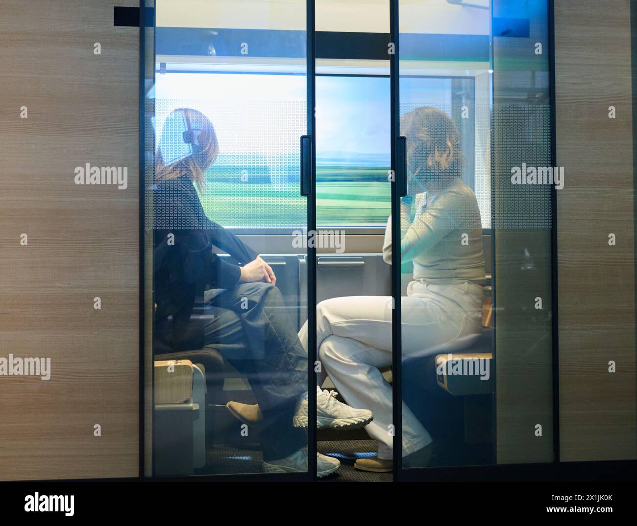 17 April 2024, Berlin: Two Deutsche Bahn employees sit in a two-person ...