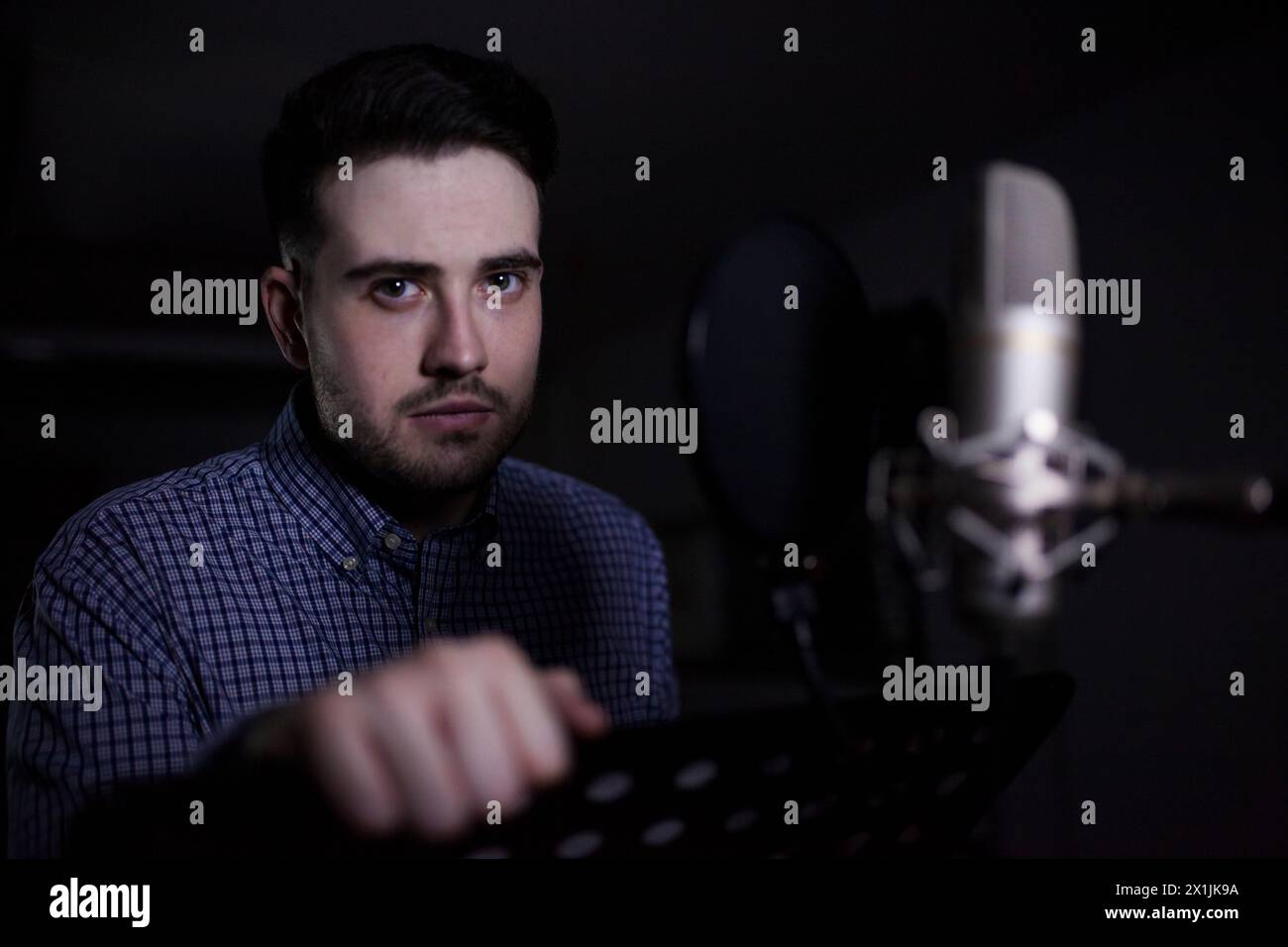 male dub actor performing in dubbing room and look camera Stock Photo ...