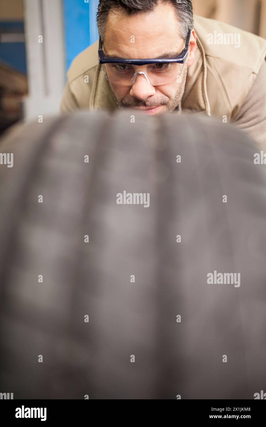 mechanic checks drawing of car wheel in mechanical workshop Stock Photo ...