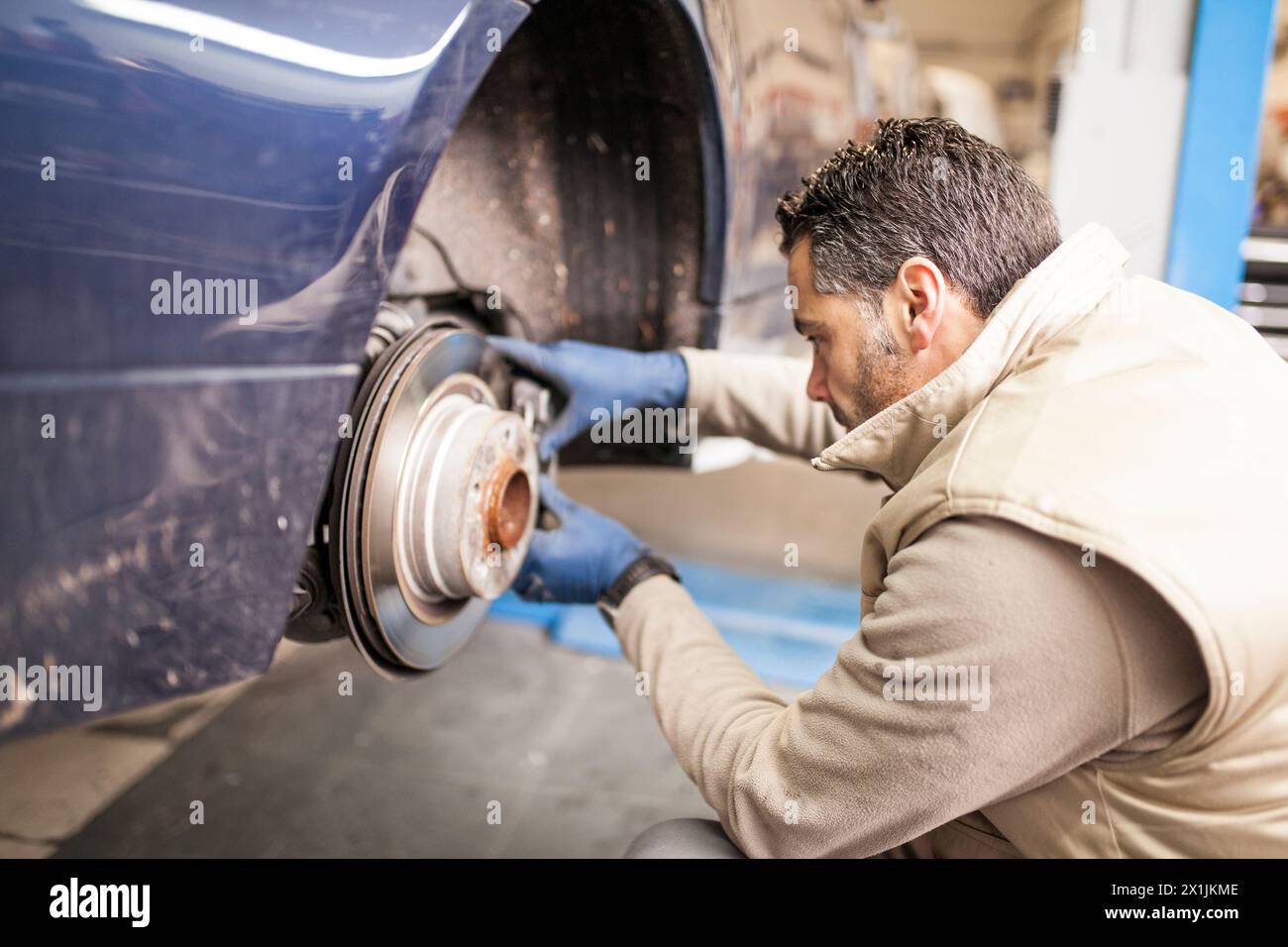 Mechanical disassembling car wheel in mechanical workshop Stock Photo ...