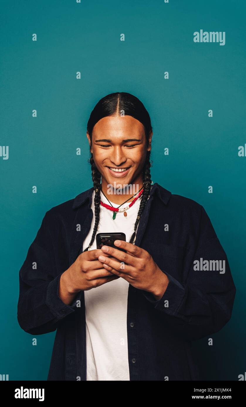 Happy man with long braided hair, wearing casual clothing and a native ...