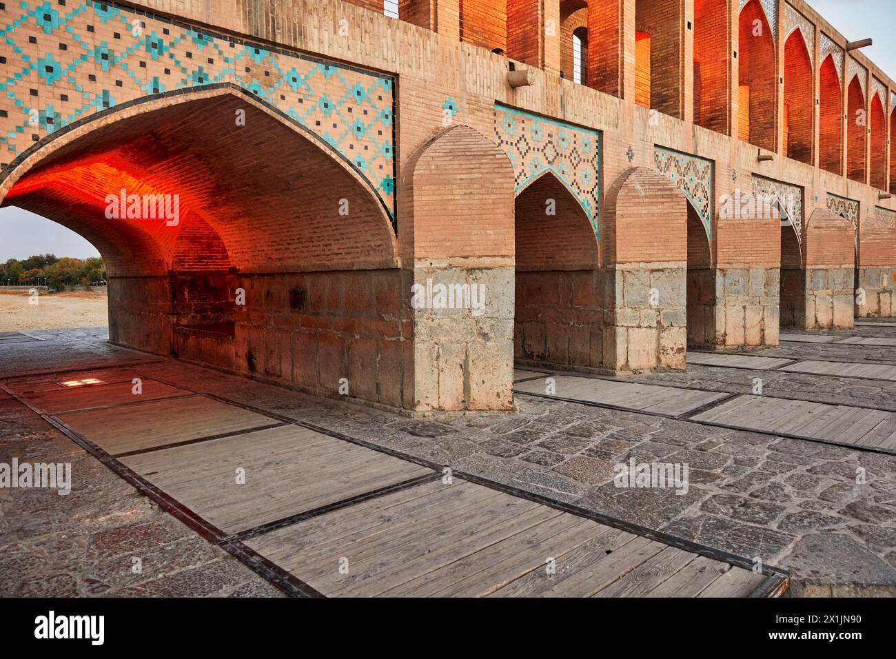 View of illuminated vaulted arches of the 17th century Khaju Bridge on ...