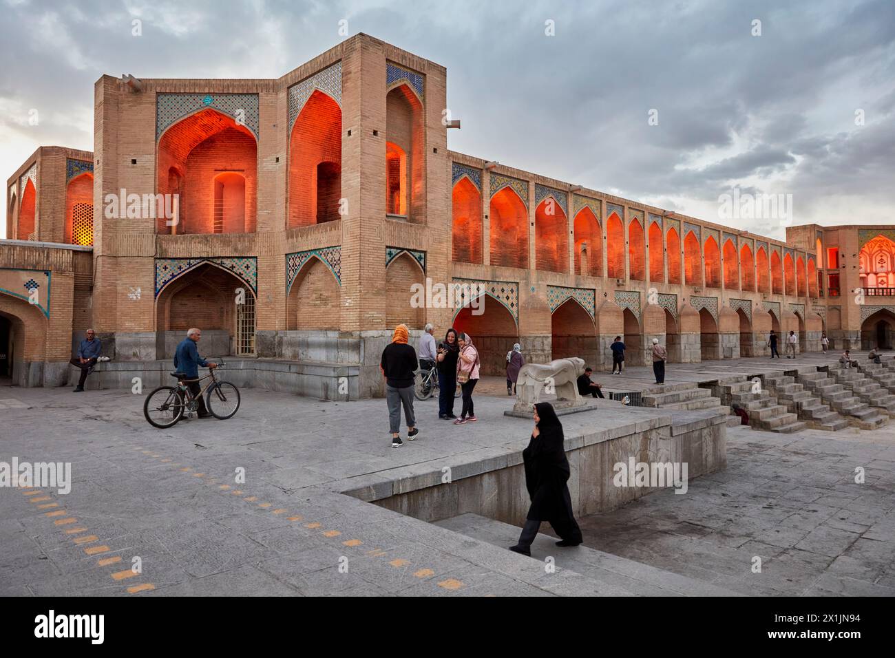People walk at the illuminated 17th century Khaju Bridge on Zayanderud ...