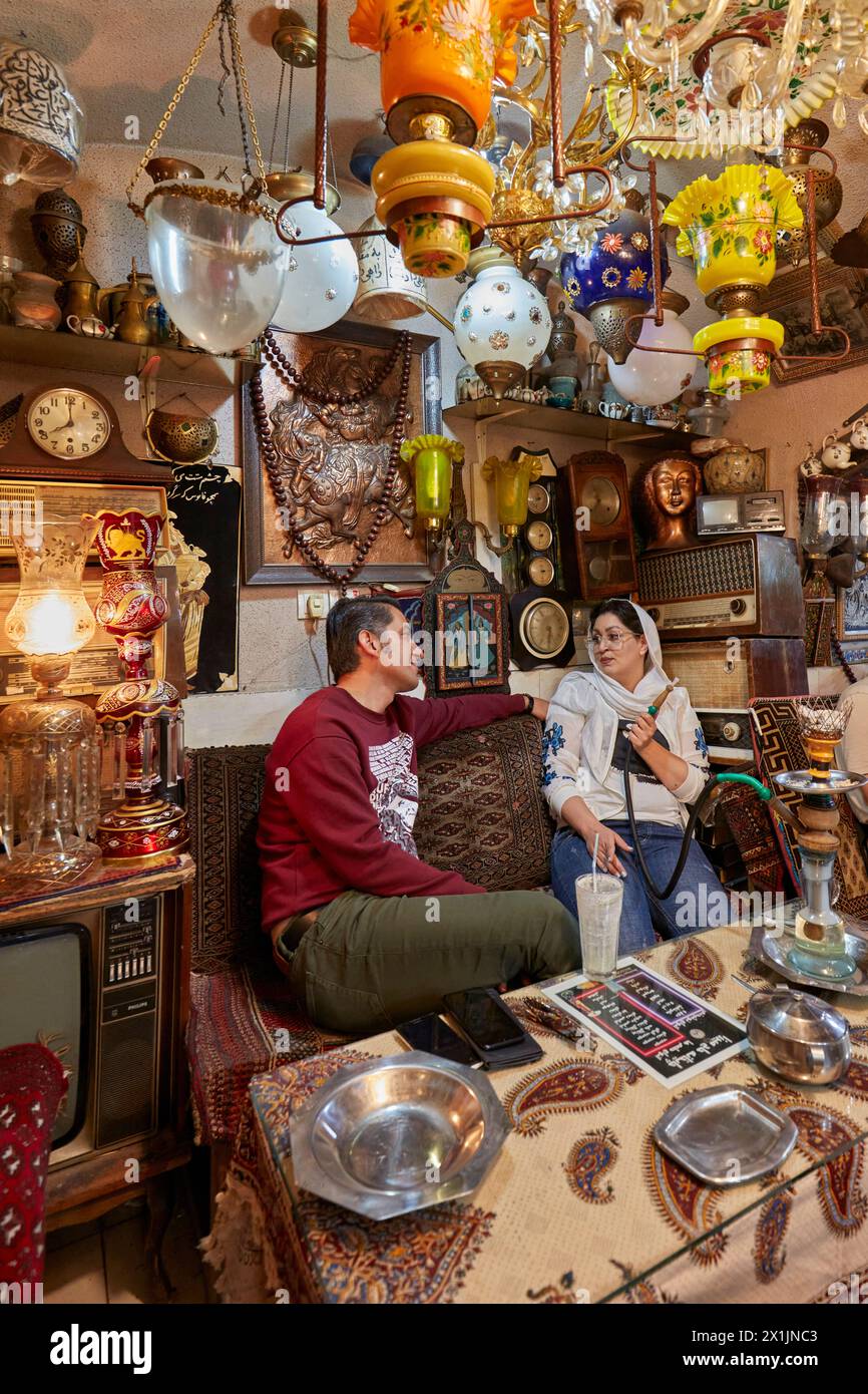 Iranian couple sits together in Azadegan Cafe with its unusual interior ...