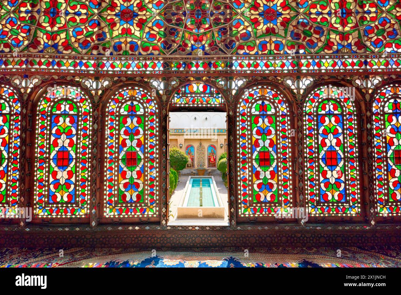 Large ornate stained glass windows in the shahneshin (a dedicated ...