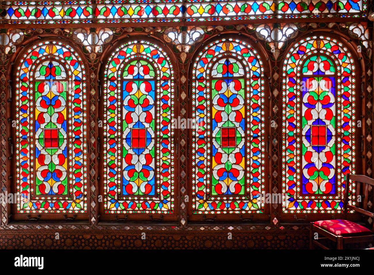 Large ornate stained glass windows in the shahneshin (a dedicated ...
