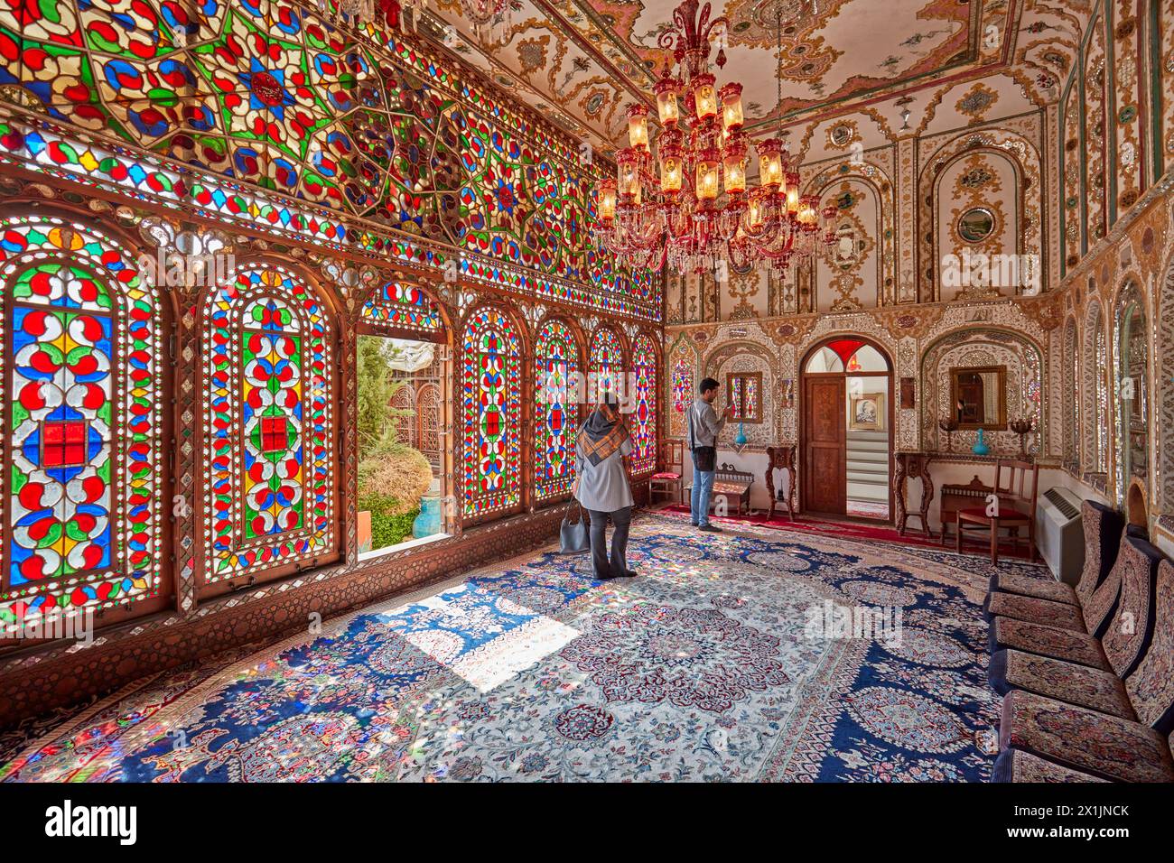 Ornate interior of the reception hall (shahneshin) with large colorful ...