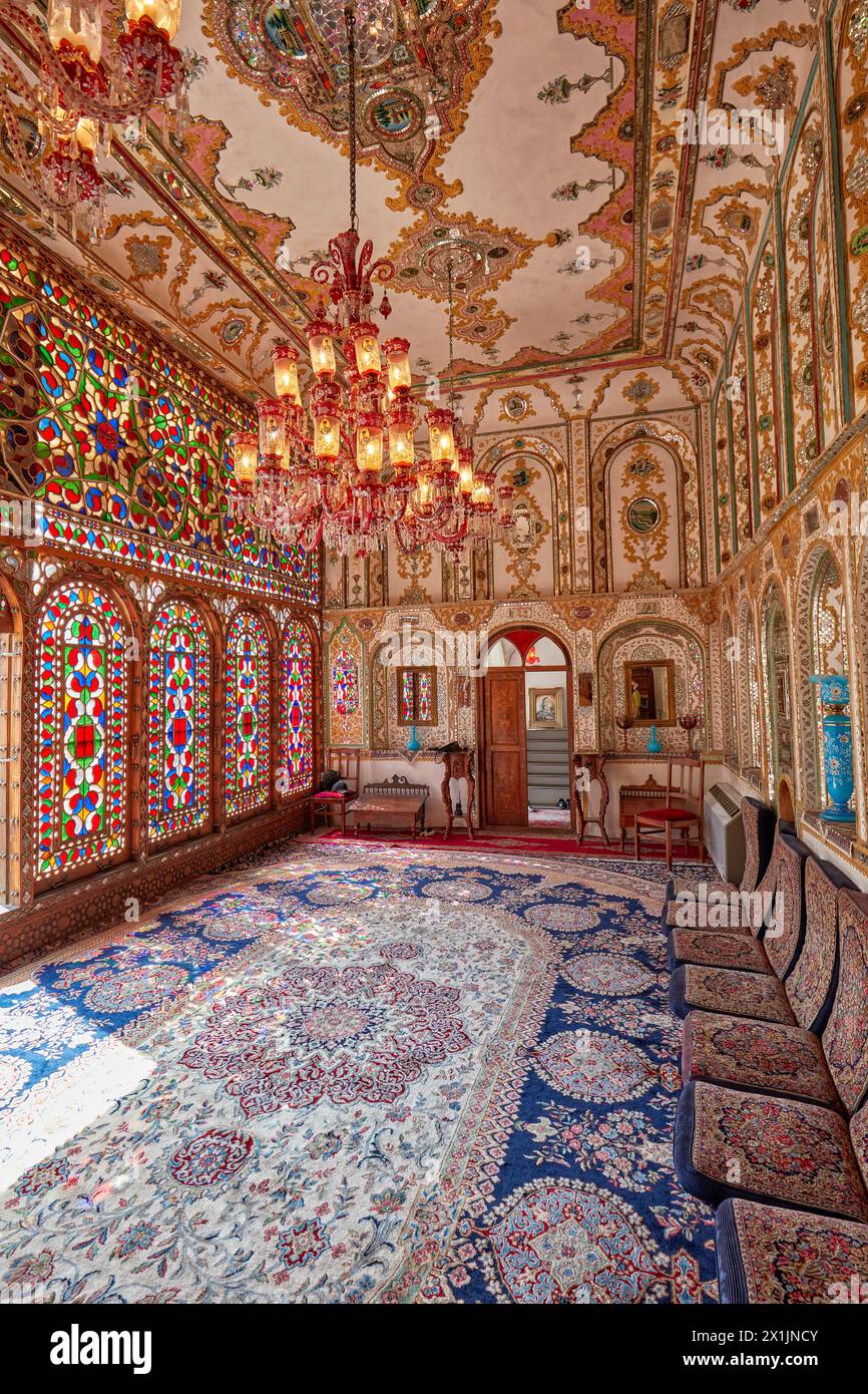 Ornate interior of the reception hall (shahneshin) with large colorful ...