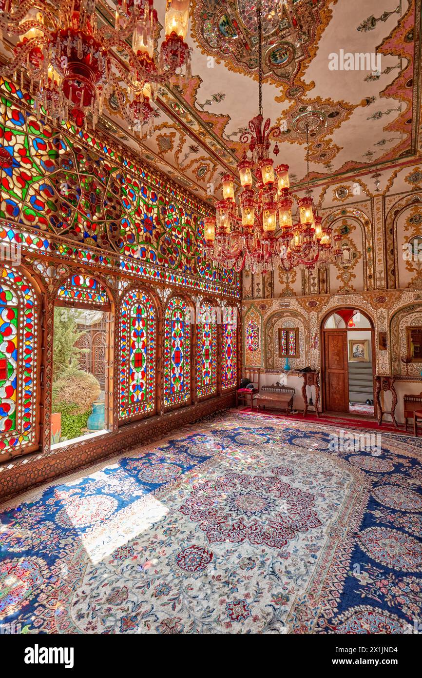 Ornate interior of the reception hall (shahneshin) with large colorful ...