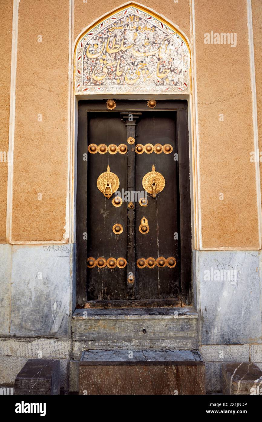 Closed front door of a traditional Persian house with two separate ...