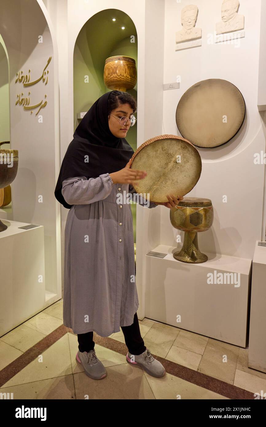 Young Iranian woman demonstrates how to play daf, a Middle Eastern ...