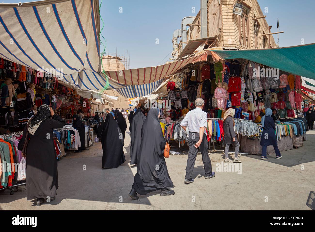 People walk in a street bazaar in the historic center of Isfahan, Iran ...