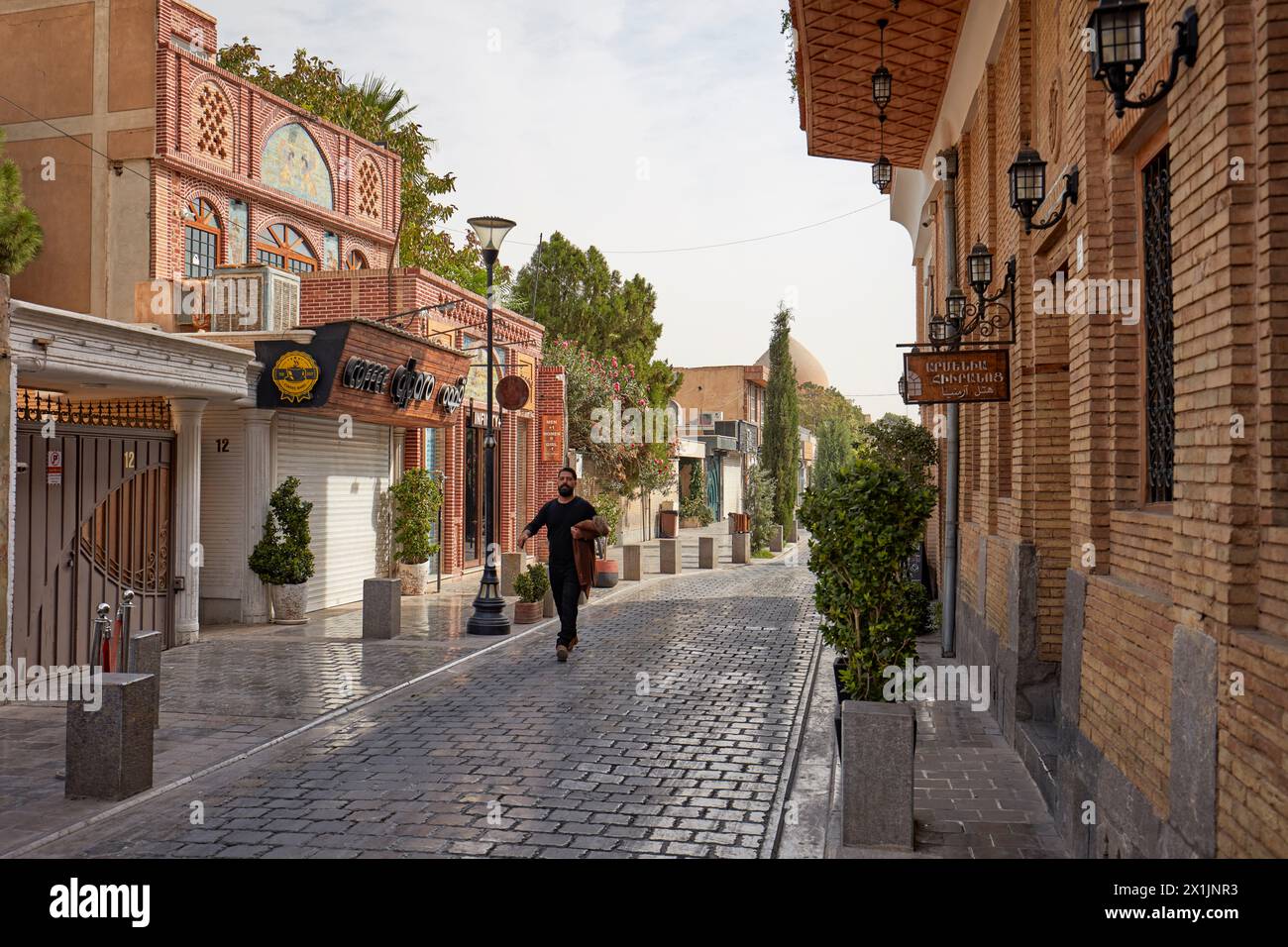 A man walks in a narrow cobbled street in the New Julfa, Armenian ...