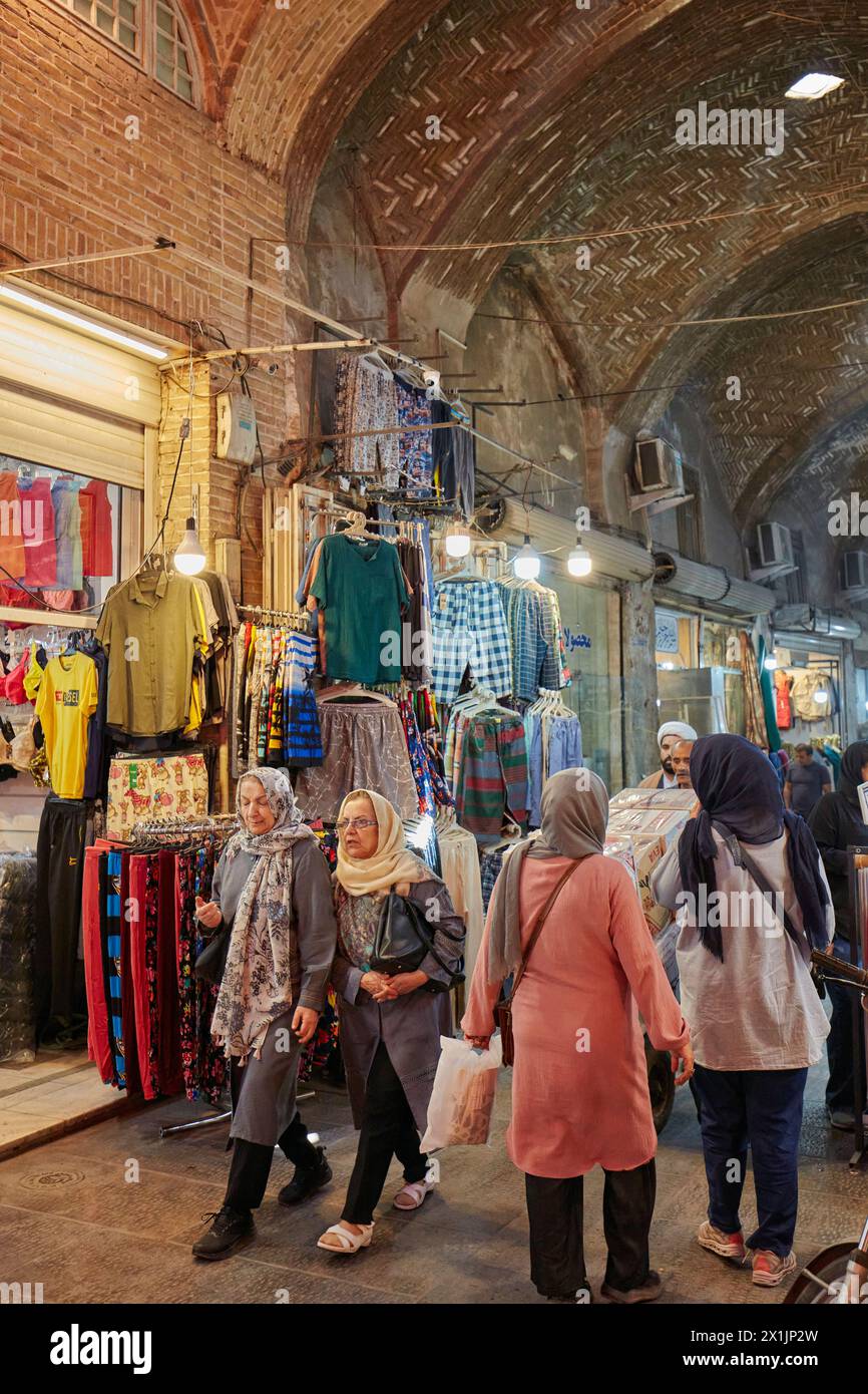 People walk in a narrow passage in the Grand Bazaar of Isfahan, Iran ...