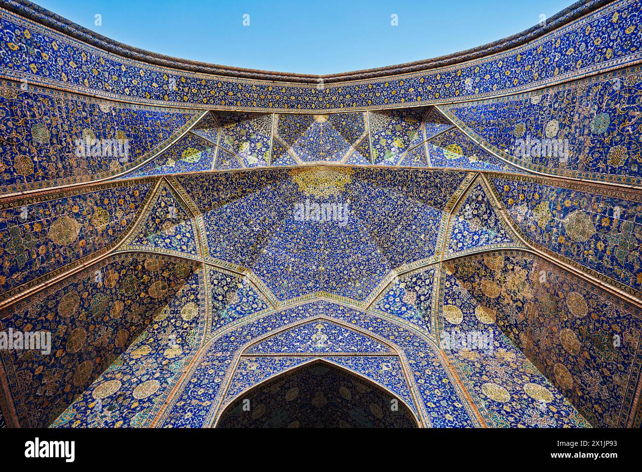 View from below of iwan’s ornate vaulted ceiling in the Shah Mosque ...