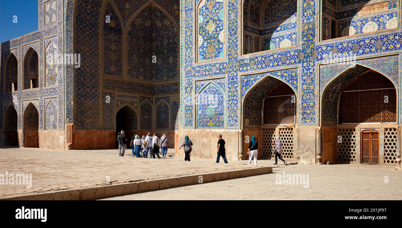 A group of tourists walk in the courtyard of the Shah Mosque (Masjed-e ...
