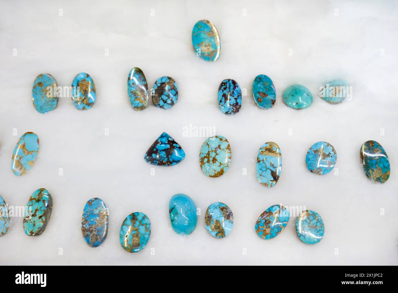 A selection of polished Persian turquoise gemstones displayed in a ...