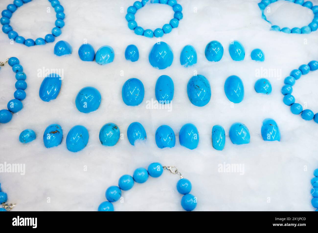 A selection of polished Persian turquoise gemstones displayed in a gift ...