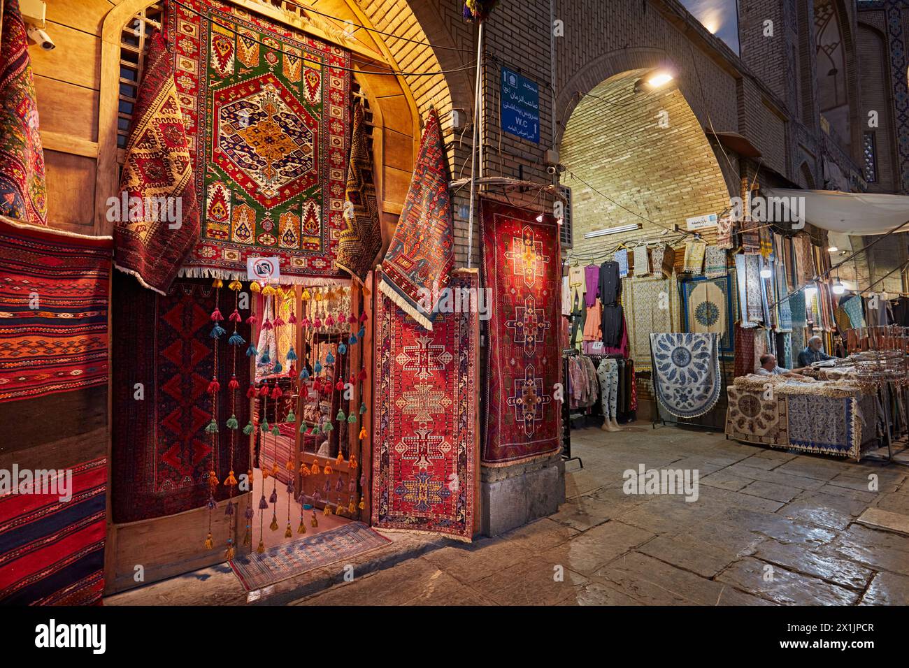 A selection of handmade Persian carpets displayed at the entrance of a ...