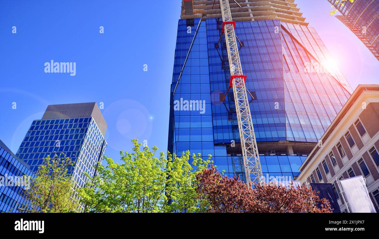 High rise building under construction. Installation of glass facade ...