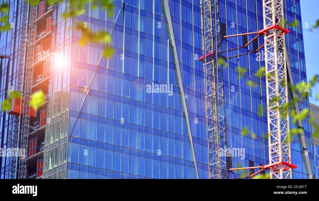High rise building under construction. Installation of glass facade ...