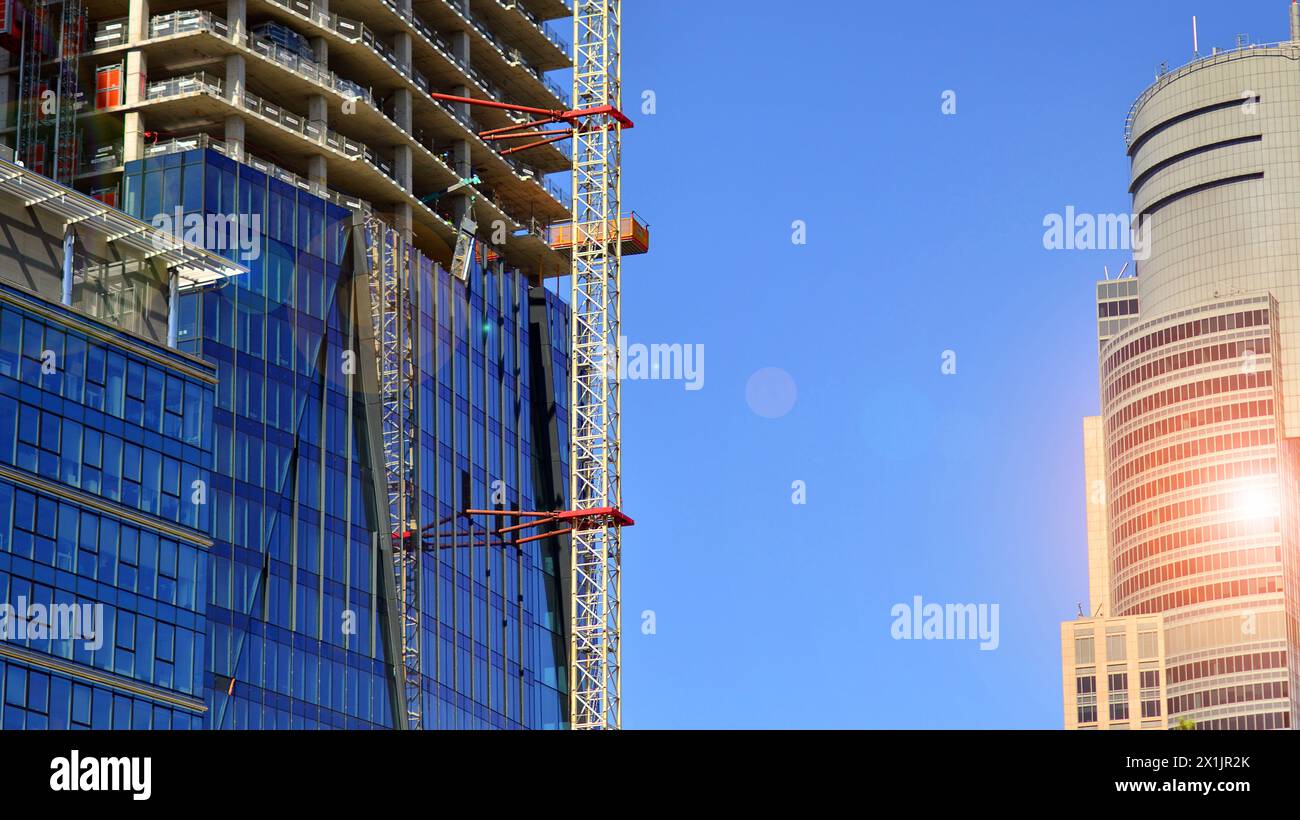 High rise building under construction. Installation of glass facade ...