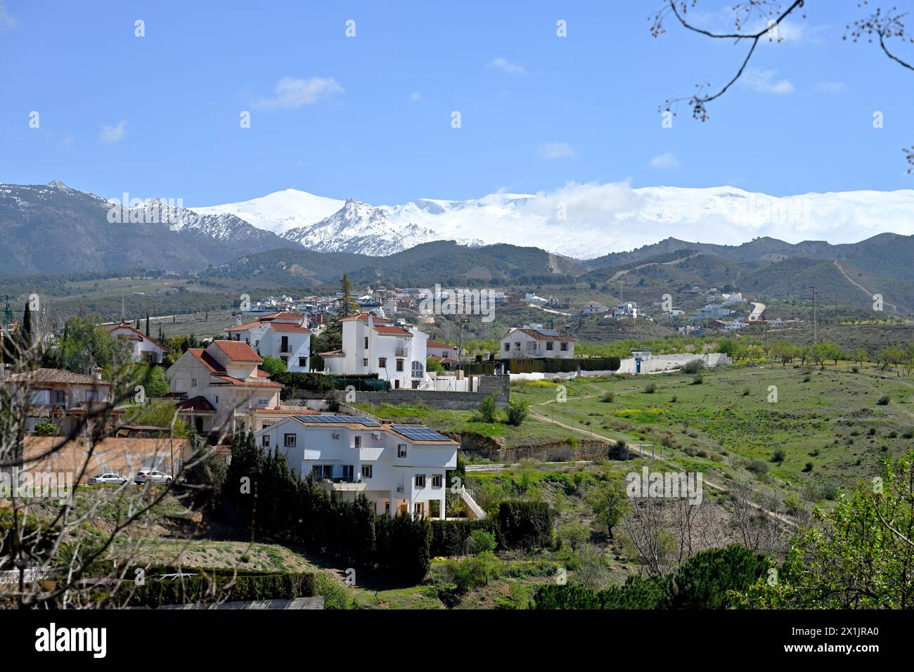 Small suburb, Gójar, of Granada with view over houses to snow caped ...