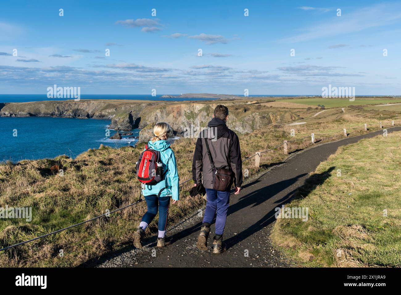 Walkers walking along the clifftop path at Bedruthan Steps in Cornwall ...