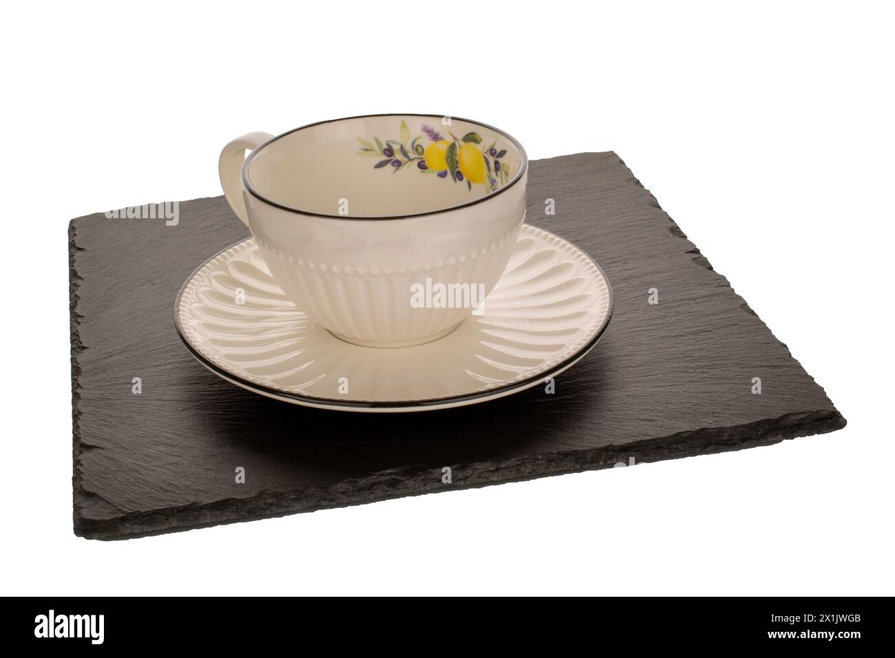 One porcelain cup and saucer on slate stone, macro, isolated on white ...