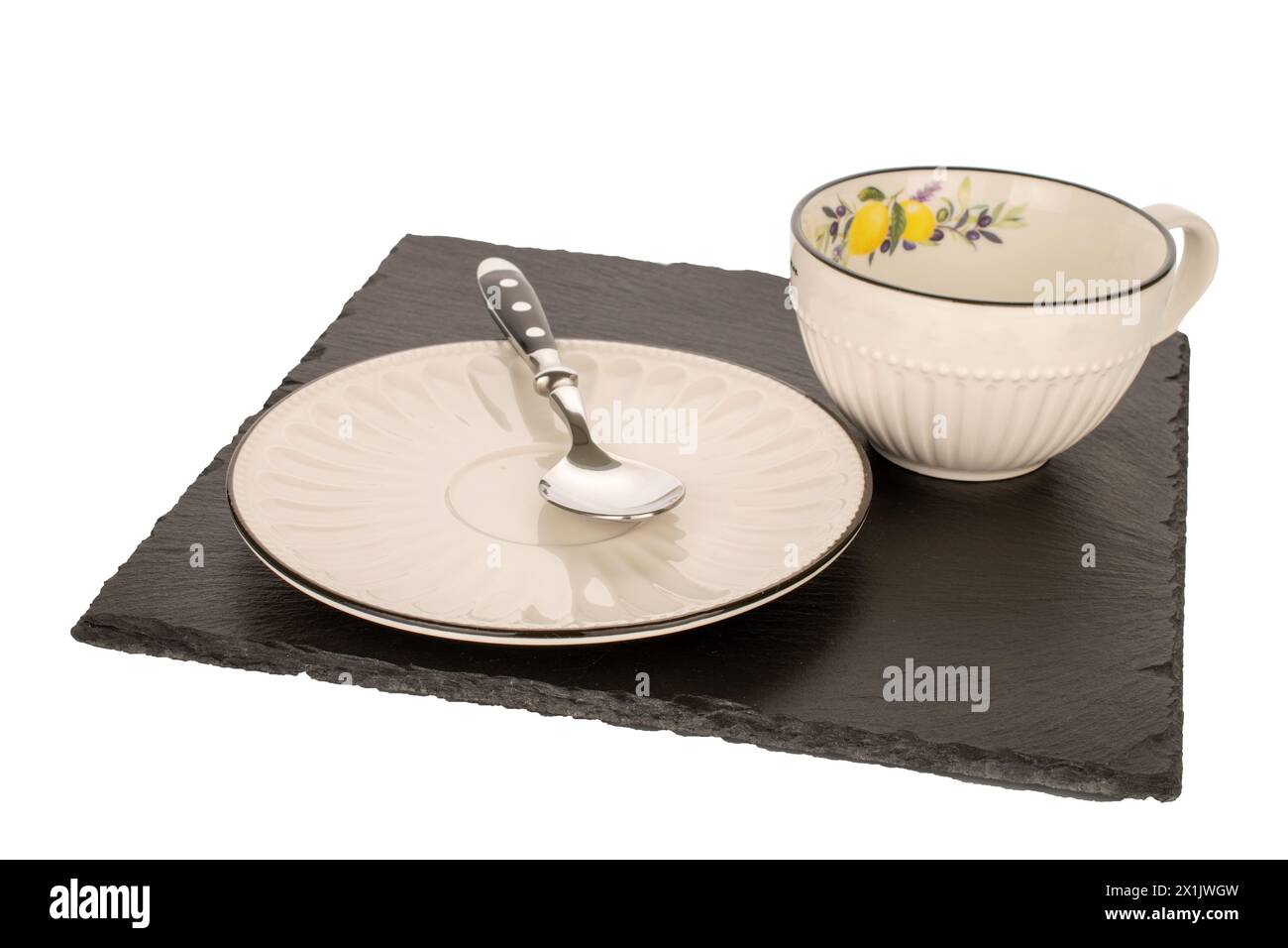 One porcelain cup and saucer on slate stone, macro, isolated on white ...