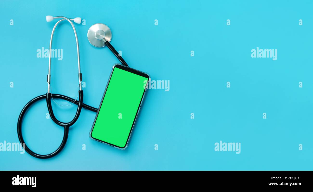 Stethoscope on a blue background and a smartphone with a green screen ...