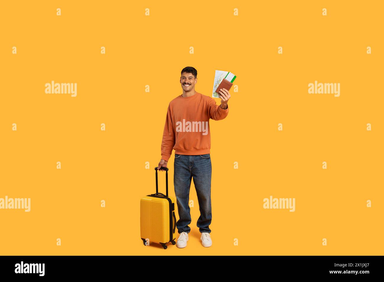 Travel ready guy with suitcase and passport Stock Photo - Alamy
