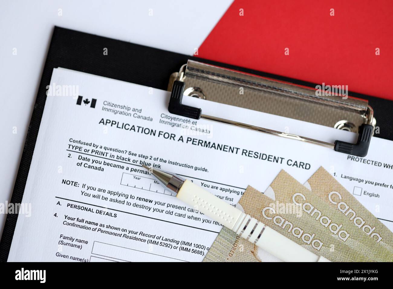 Application for permanent resident card on table with pen and canadian ...